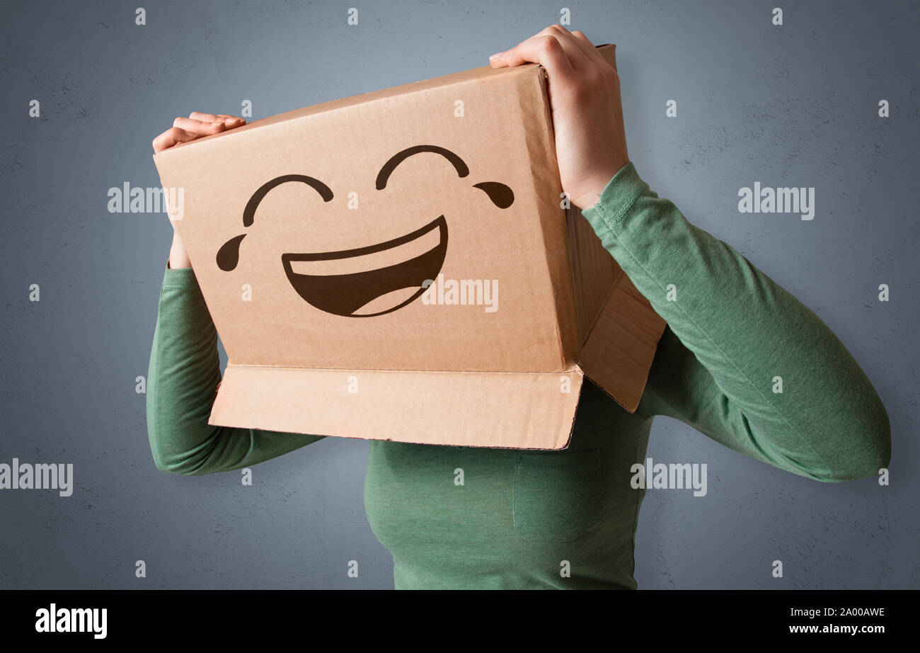 Funny woman wearing cardboard box on her head with smiley face Stock ...
