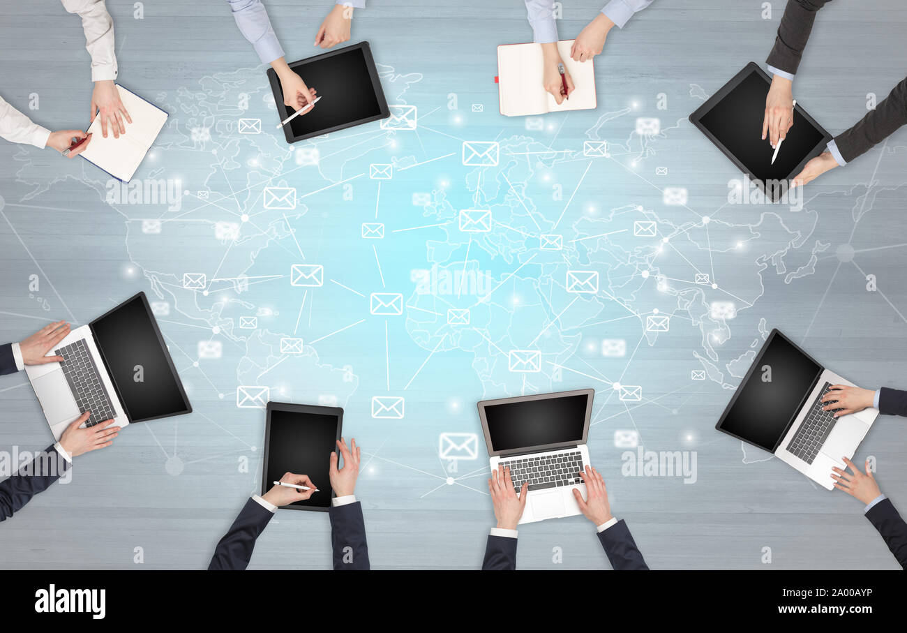 Group of people with devices in hands working in team on tablets ...