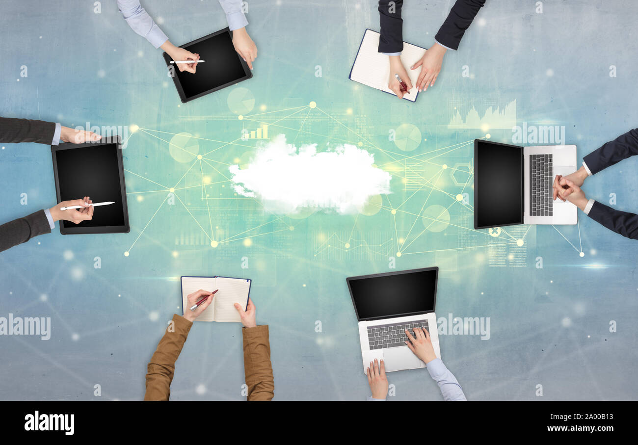 Group of people with devices in hands working on reports with online ...
