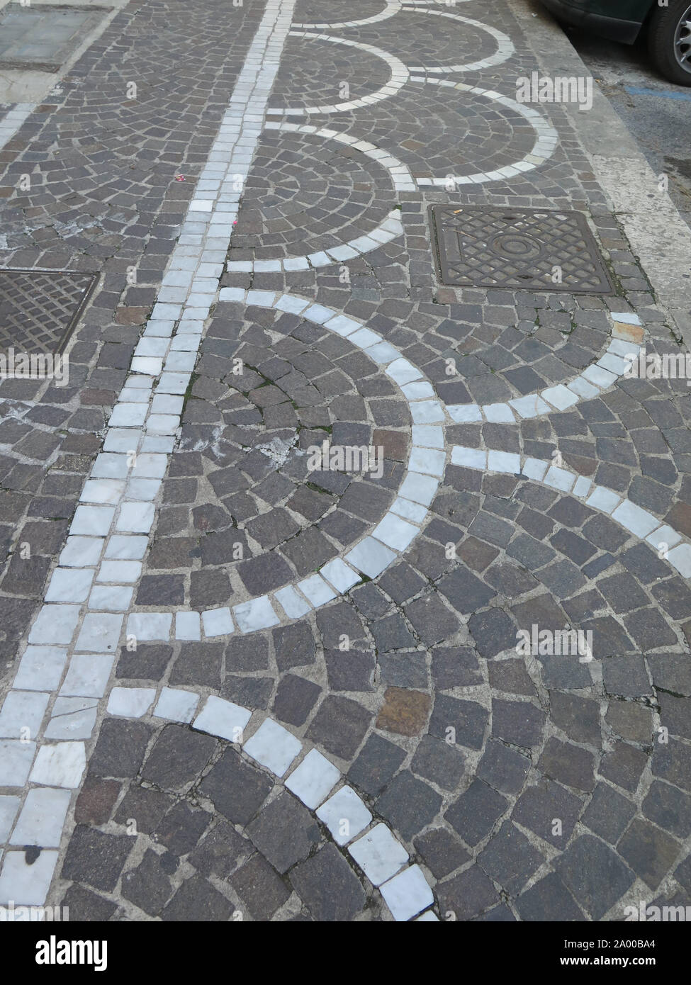 Pavement in Italian town with white semi circles Stock Photo - Alamy