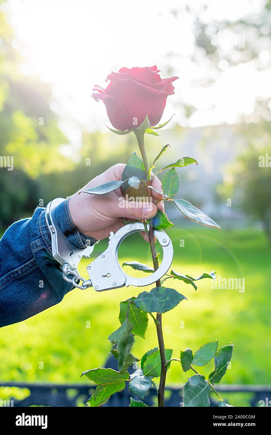 outdoors, close up, the hand of a man in leather gloves and handcuffs ...