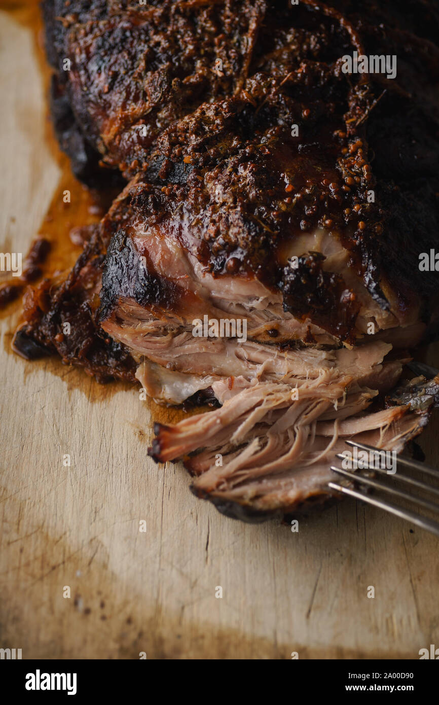 Slow-cooked pork with sugar glazing. Close up view with vintage fork ...