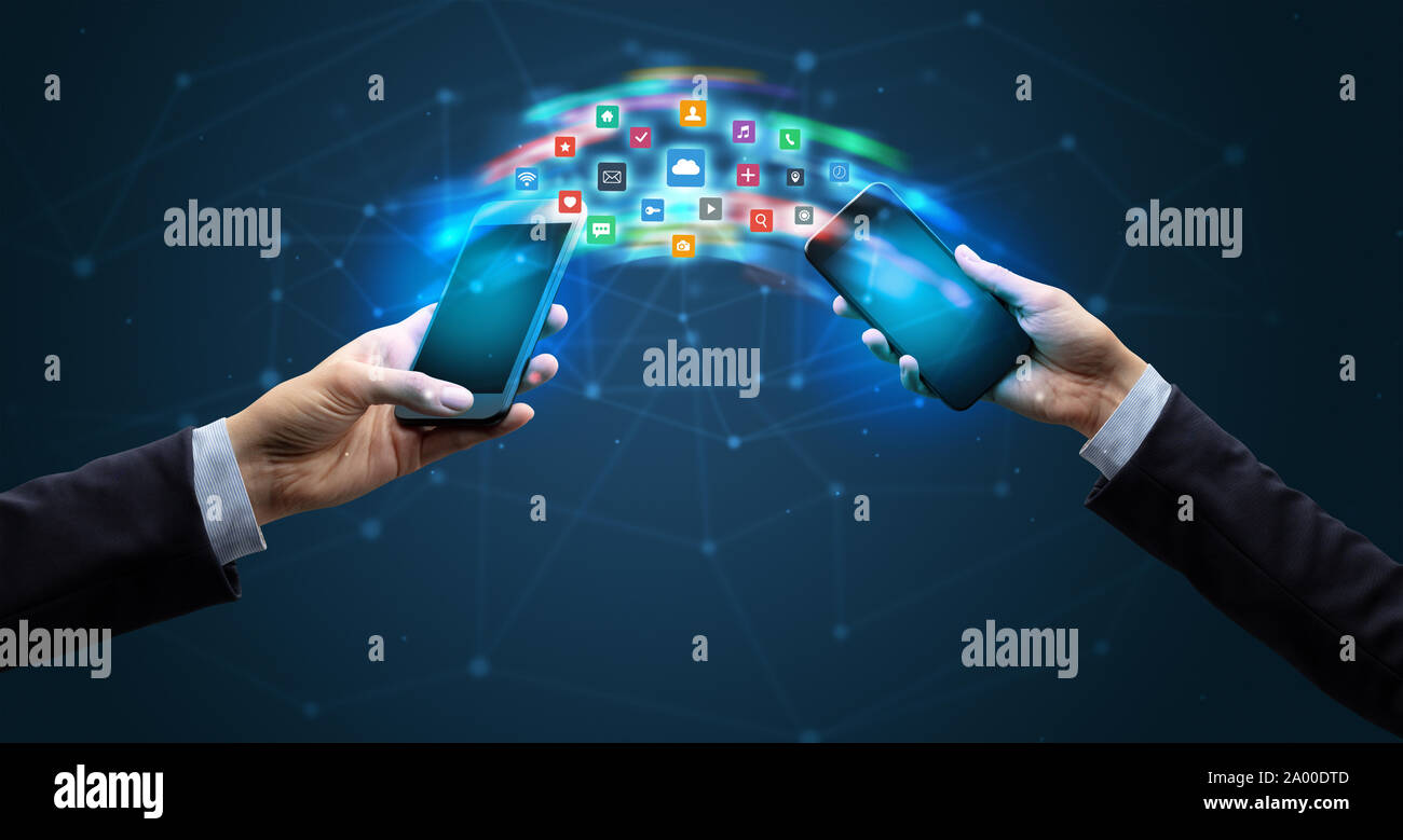 Two mobile phones syncing applications concept Stock Photo - Alamy