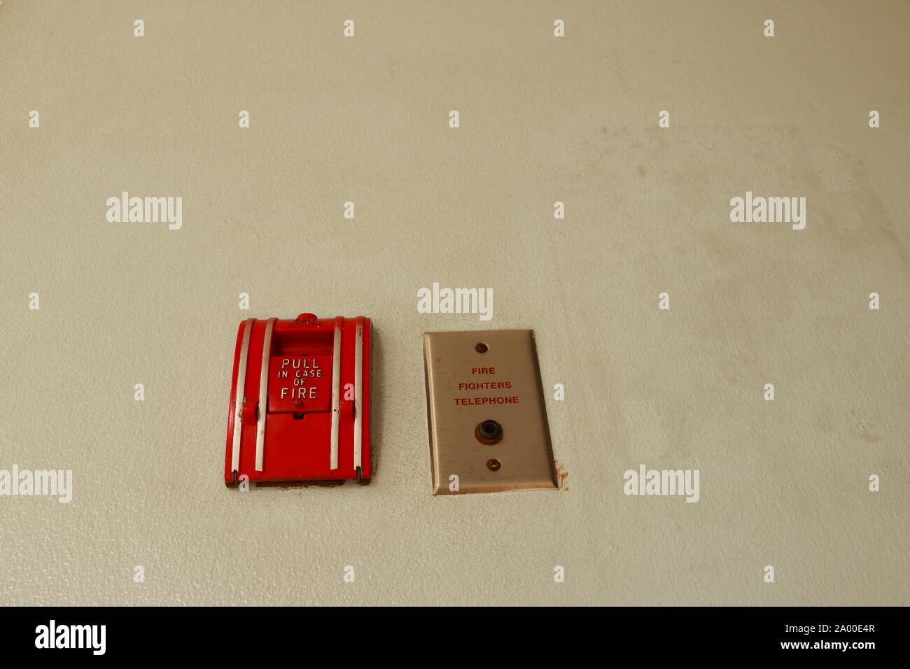 Closeup manual pull station of fire alarm system installed on the wall ...