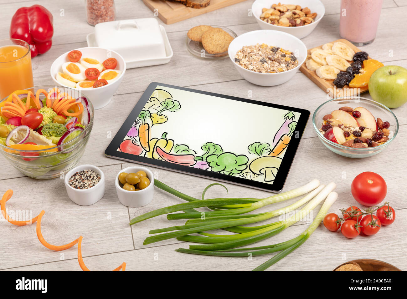 Healthy food composition with tablet Stock Photo - Alamy