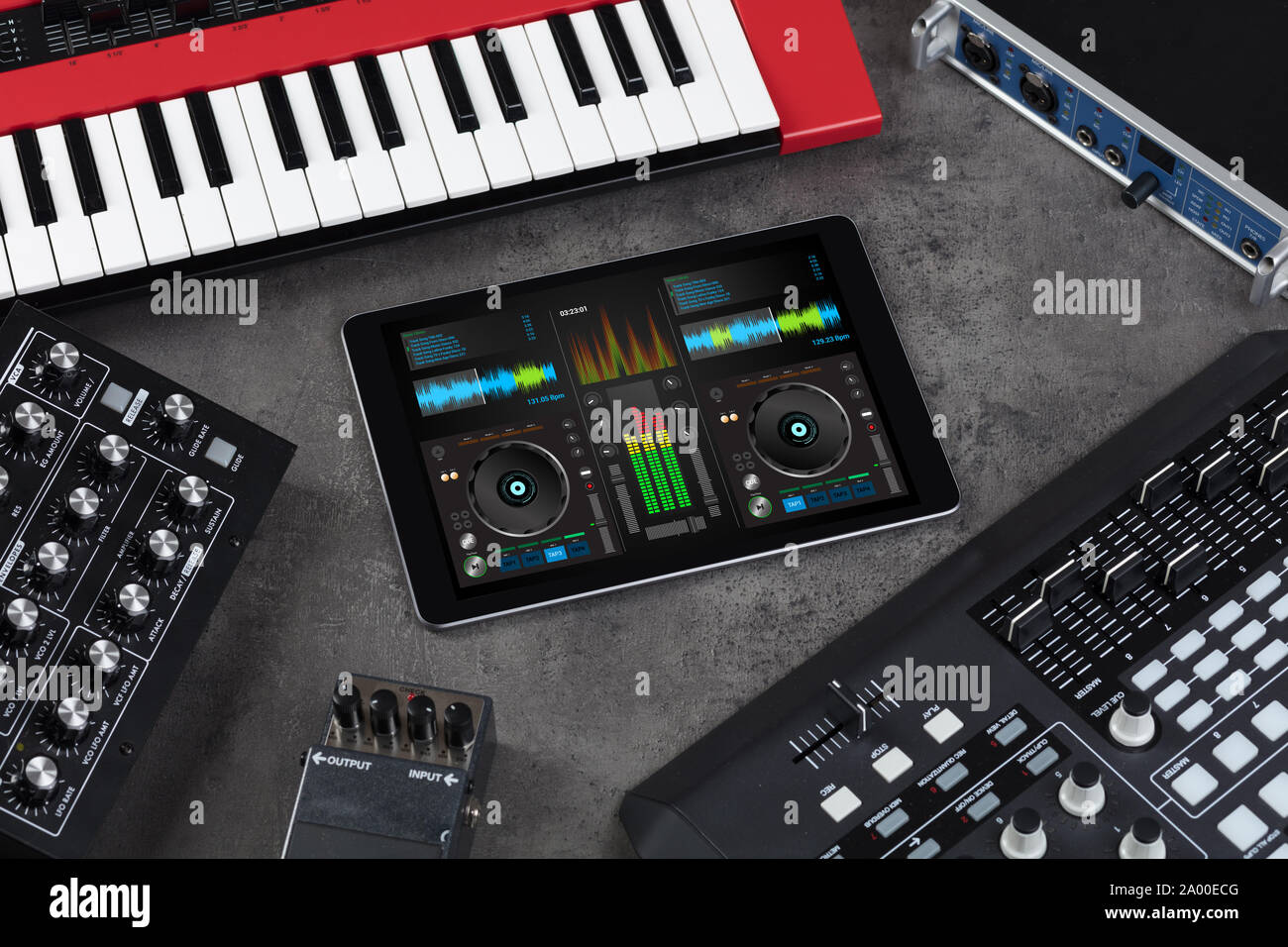 Mixing music on tablet with electronic music instruments concept Stock ...