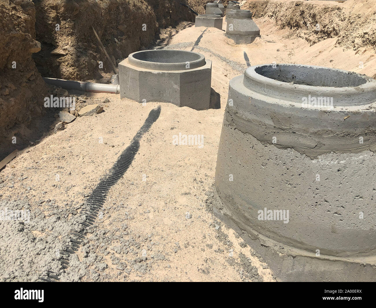 Storm water drainage reinforced concrete wells in the dug trench. Water ...
