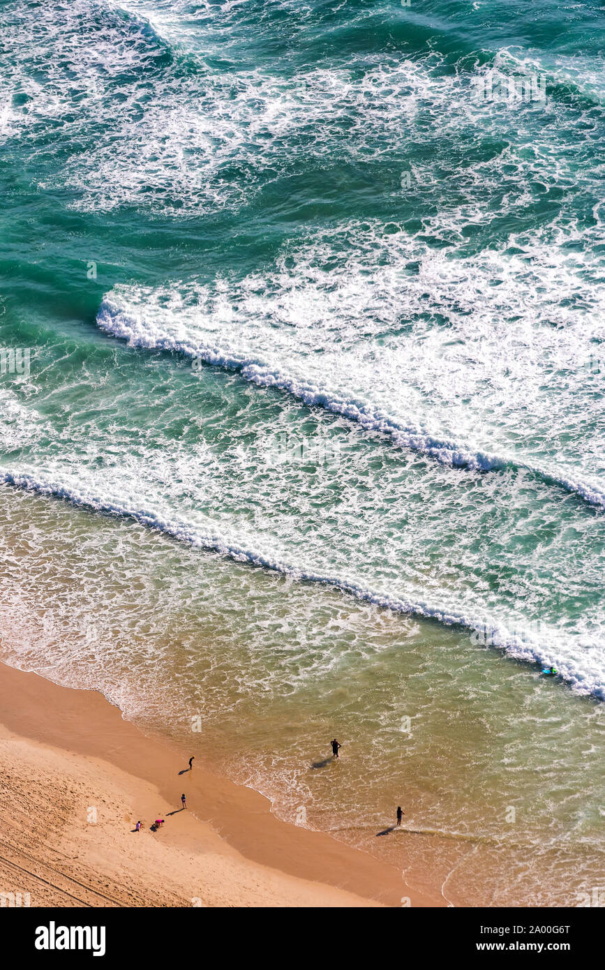 Aerial view from above of ocean, sea beach and water waves with people ...