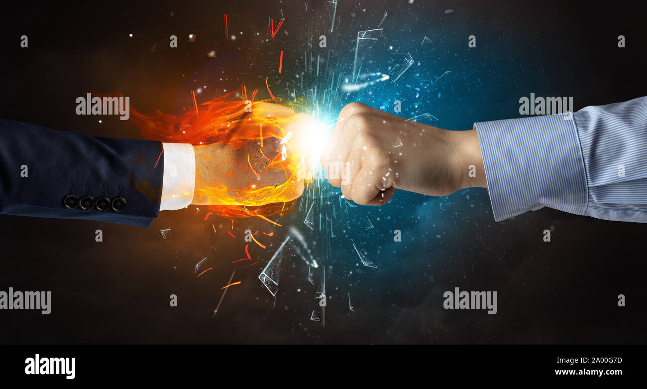 Two hands fighting and breaking glass into small pieces with fire and ...
