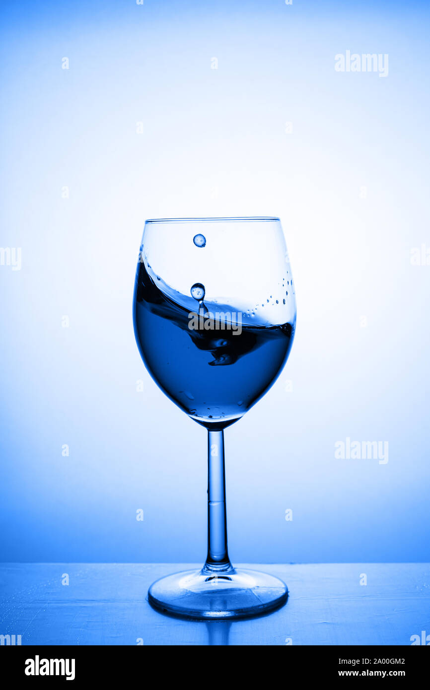 Glass with water up and splash Stock Photo - Alamy