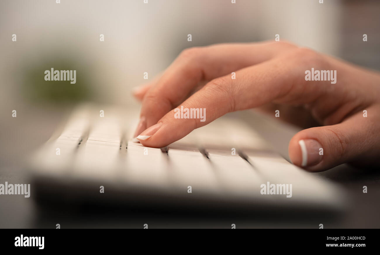 Hand typing on keyboard with office concept Stock Photo - Alamy