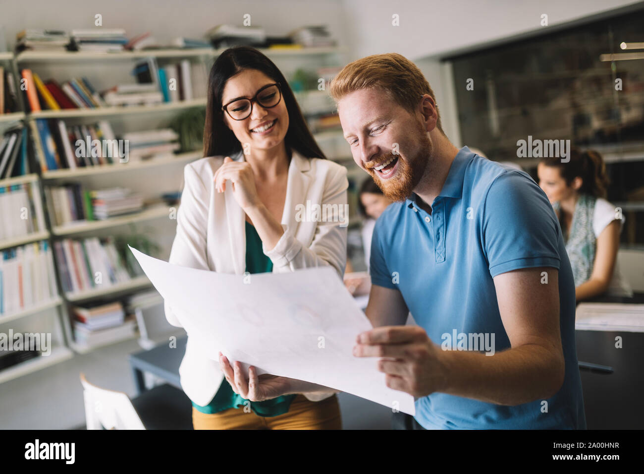 Team of colleagues brainstorming together while working in modern ...