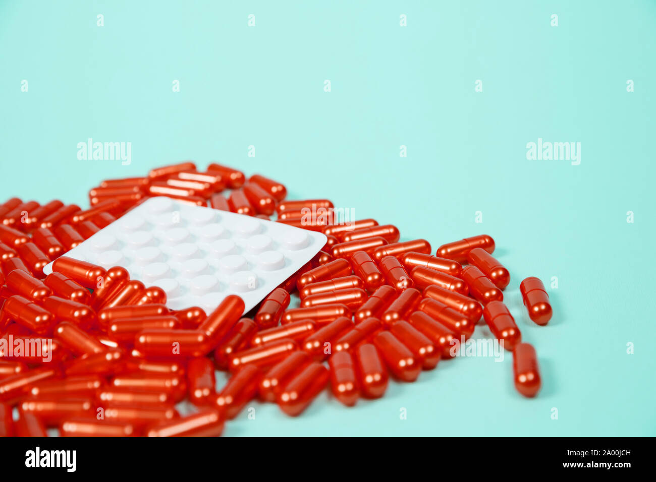 Golden pill capsules on blue background Stock Photo - Alamy