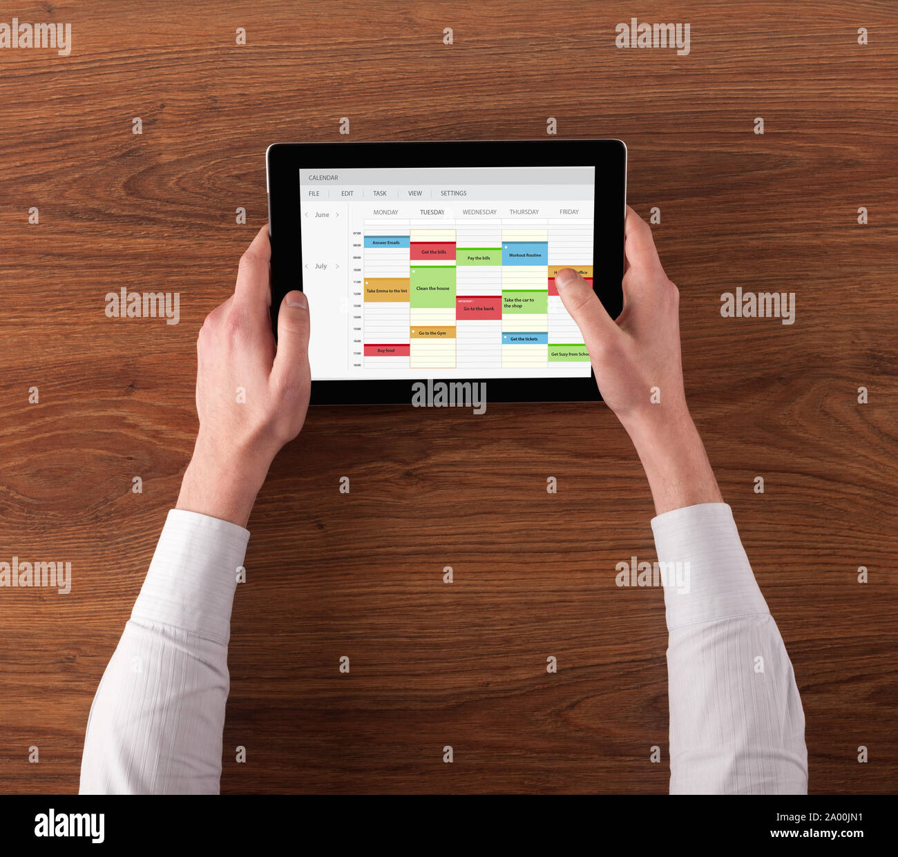 Hand holding tablet with timetable and calendar concept Stock Photo - Alamy