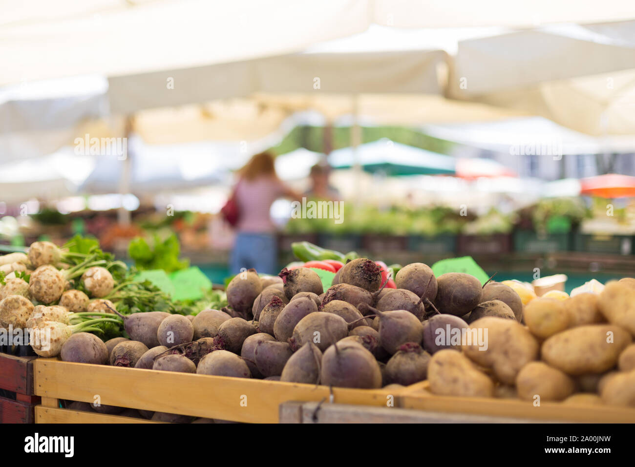 Farmers' food market stall with variety of organic vegetable. Vendor ...