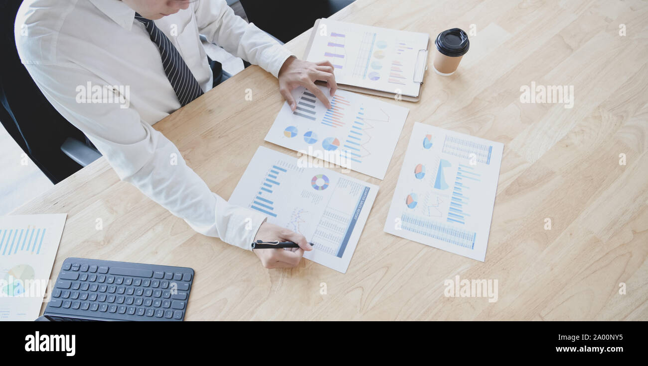 Young hard-working businessman analysing his investment plan with ...