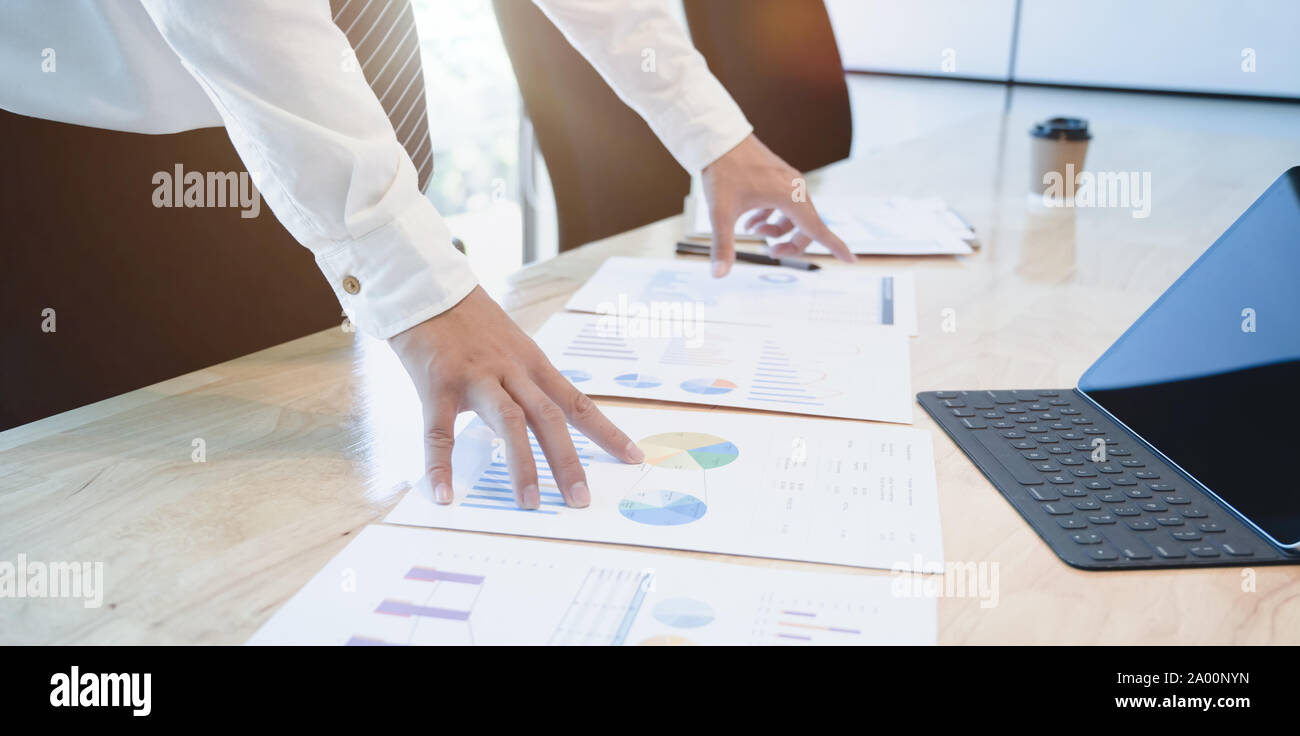 Young professional businessman analysing his investment plan with ...