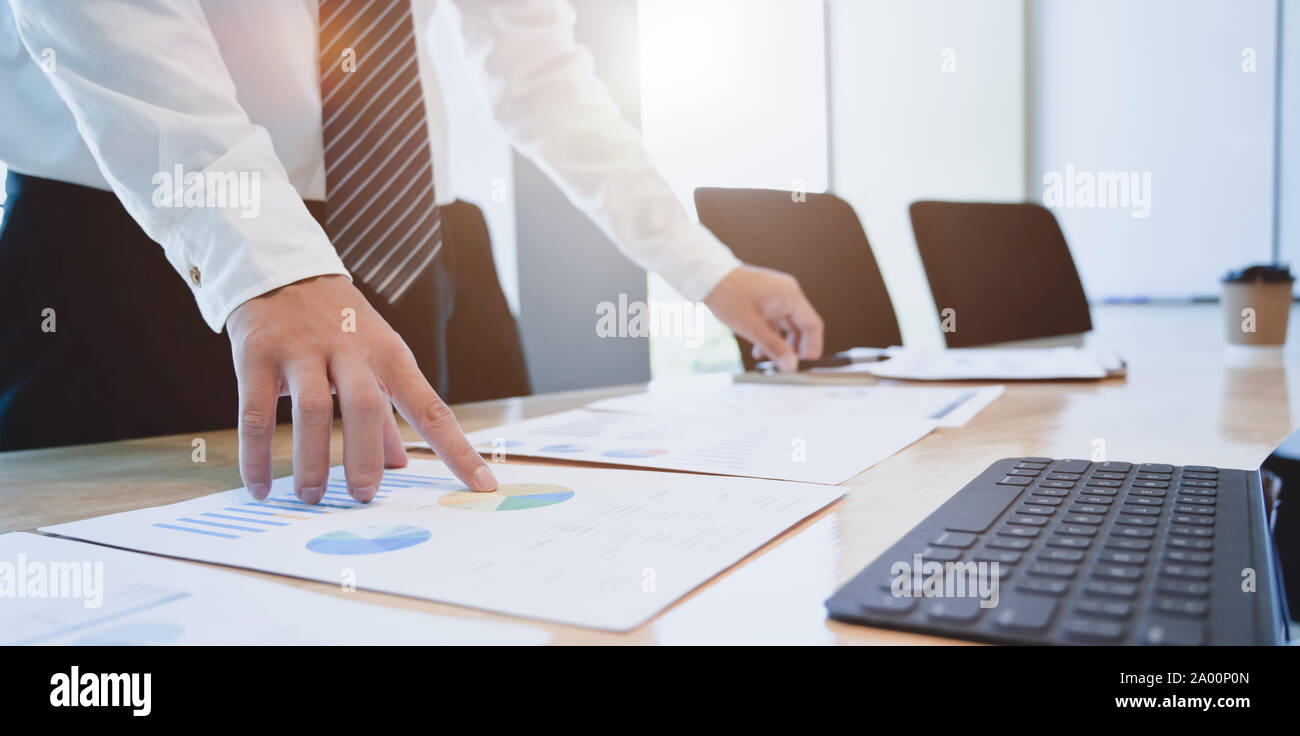 Young hard-working businessman analysing his investment plan with ...