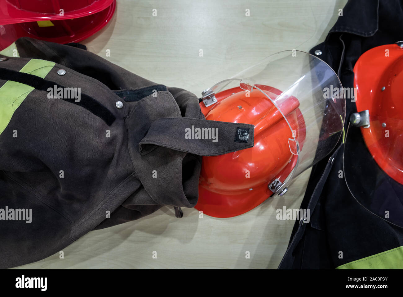 Fire proof uniform and helmet on desk. Top view Stock Photo - Alamy