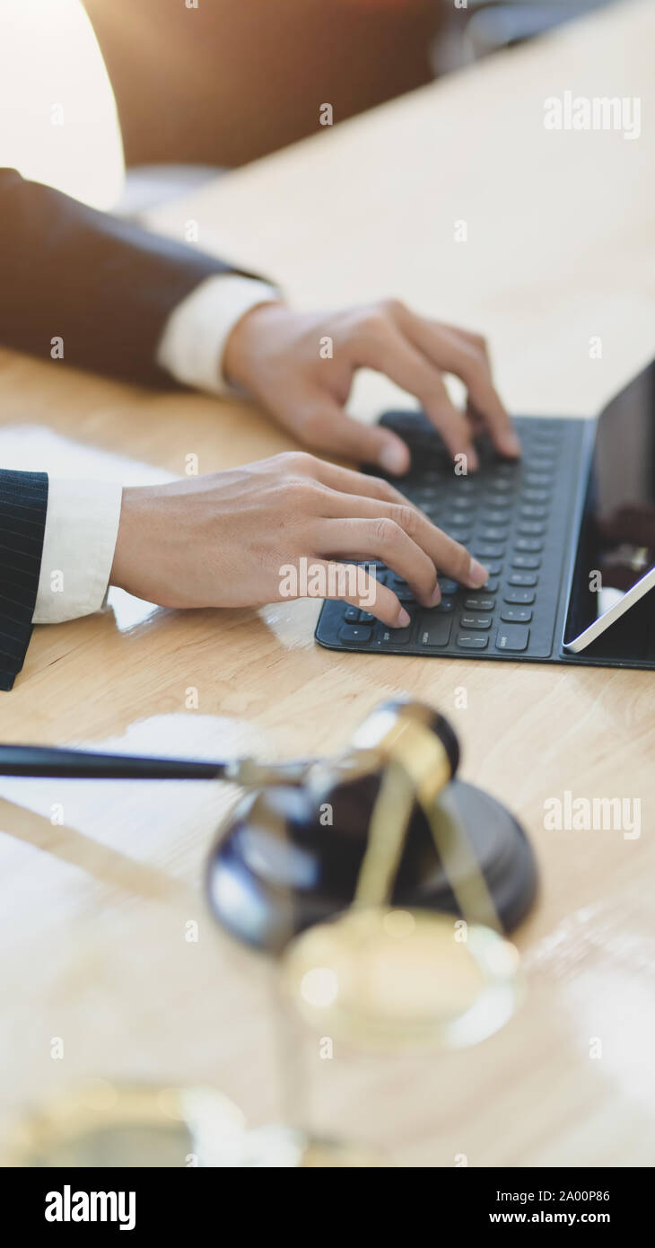 Close-up view of male legal advisor working on a laptop and providing ...