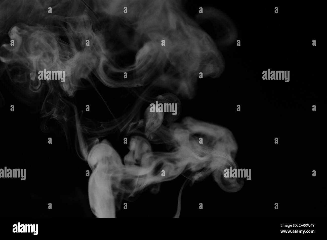 White smoke on a black background. Texture of smoke. Clubs of white ...