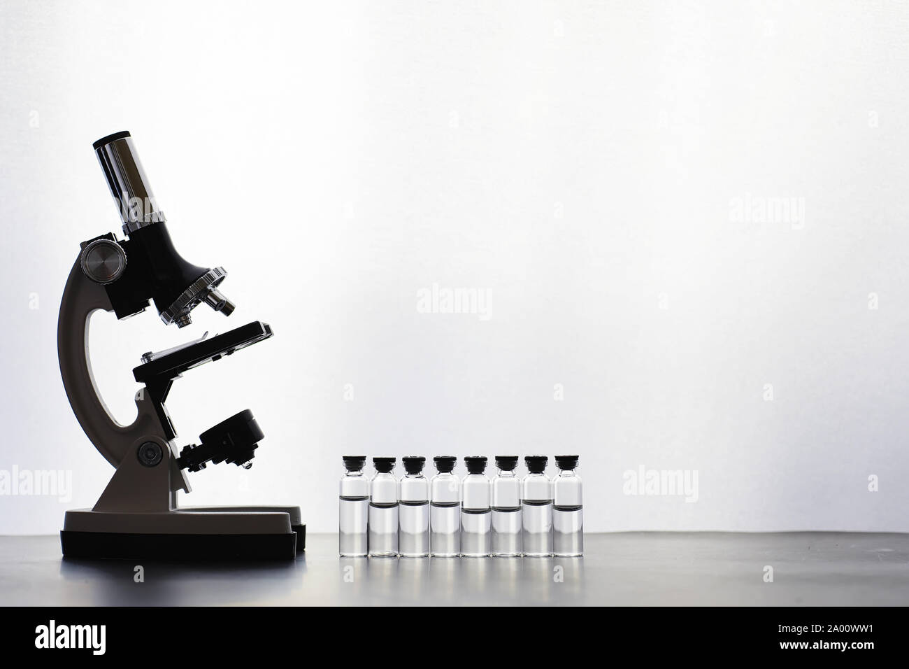 Research laboratory. Test tubes and microscope on the table on a white ...