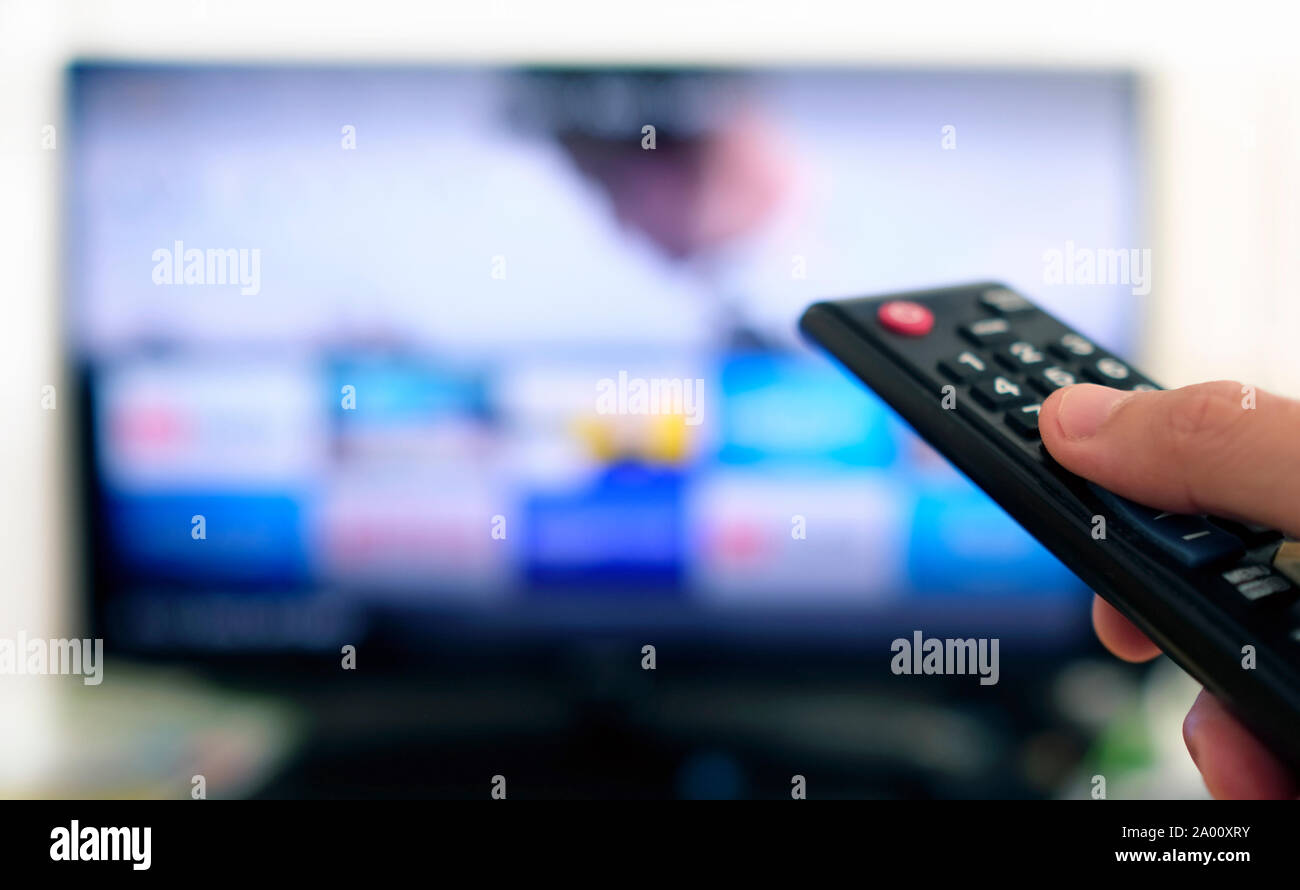 Remote control and screen - binge watching the favourite TV show Stock ...