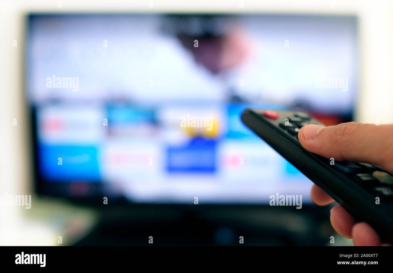 Remote control and screen - binge watching the favourite TV show Stock ...