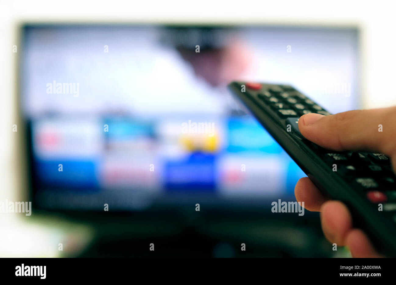 Remote control and screen - binge watching the favourite TV show Stock ...