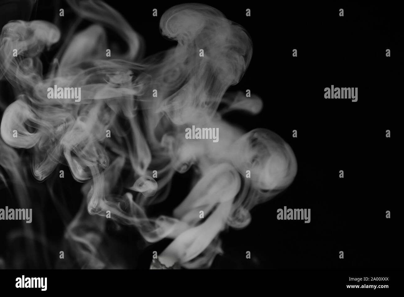 White smoke on a black background. Texture of smoke. Clubs of white ...