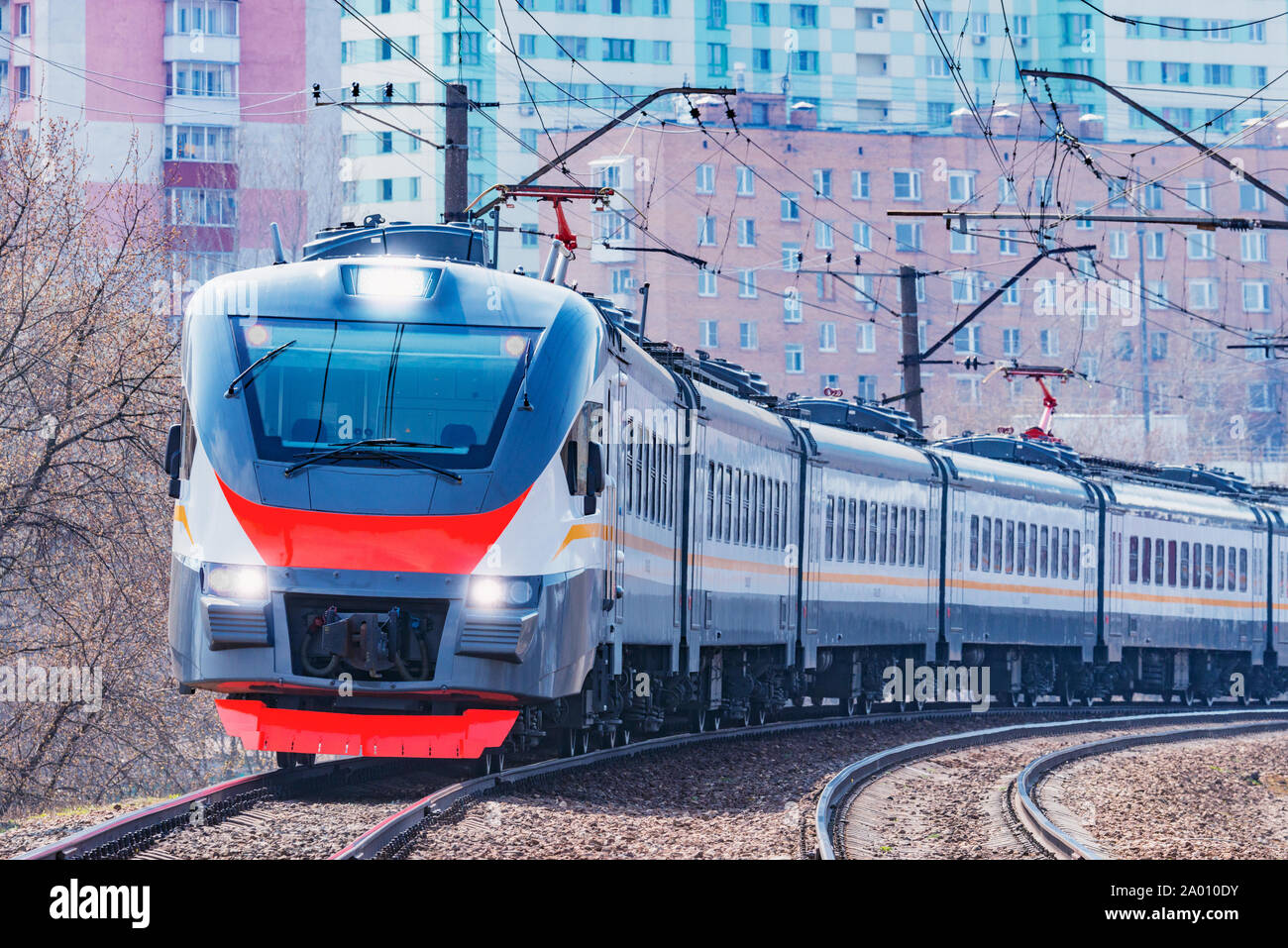 Modern high-speed train moves on the city background Stock Photo - Alamy