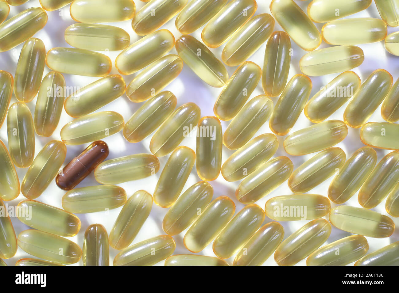 Medical drugs transparent capsules of yellow color Stock Photo - Alamy