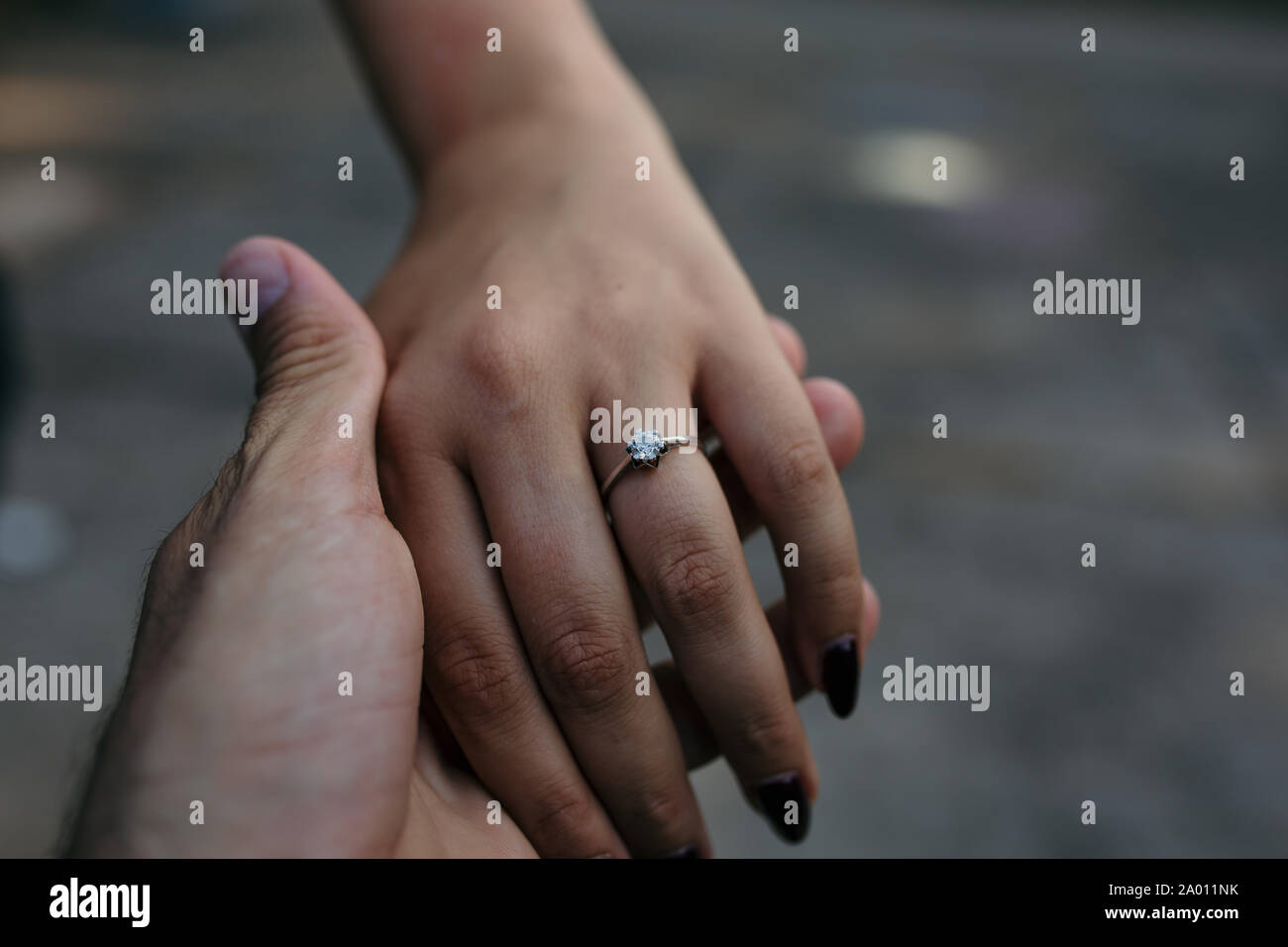 Hand holding diamond ring hi-res stock photography and images - Alamy