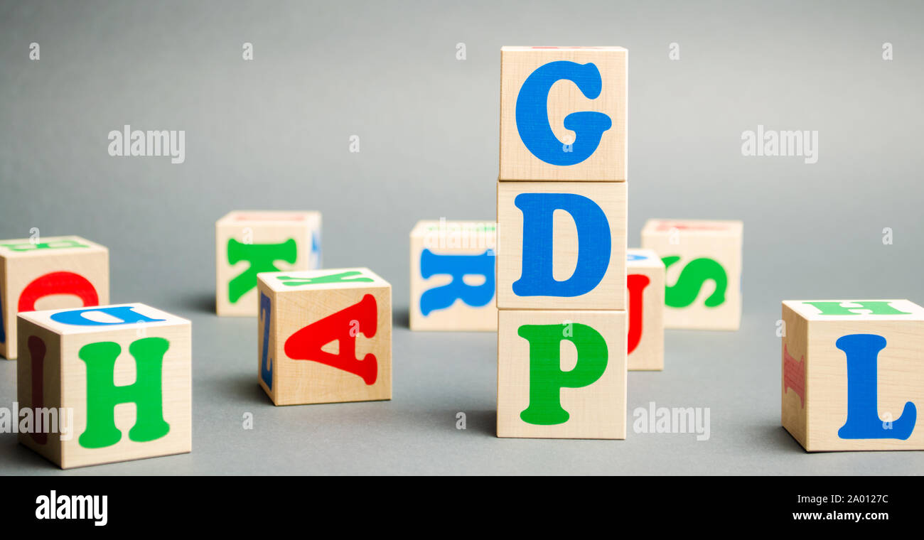 Wooden blocks with the word GDP ( Gross domestic product ). Financial ...