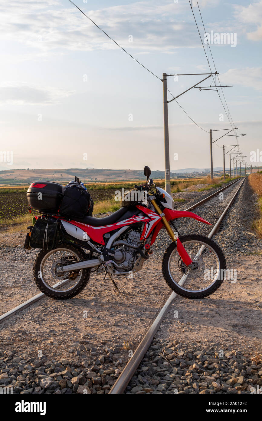 Motorcycle loaded on the bag, on train tracks Stock Photo - Alamy