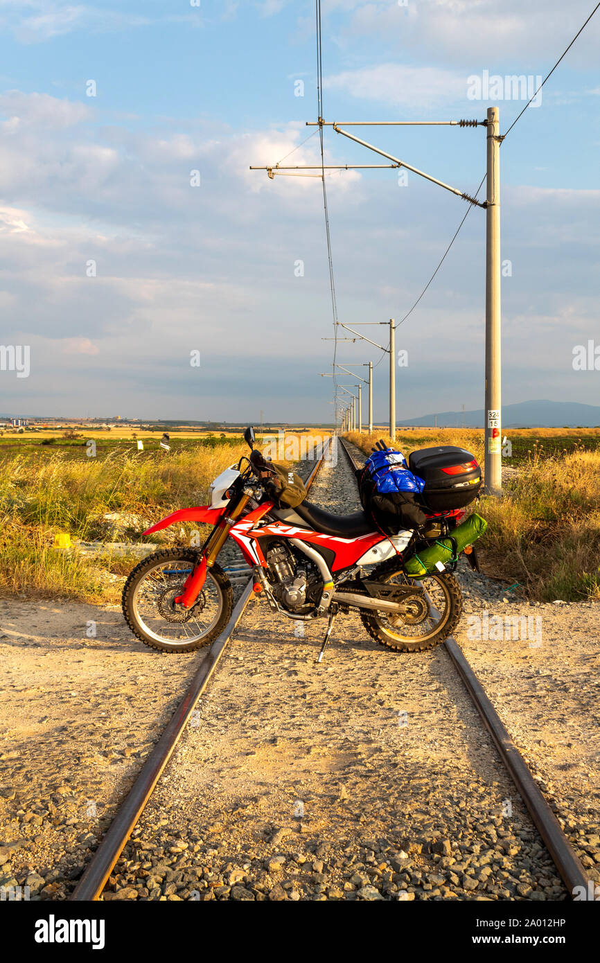 Motorcycle loaded on the bag, on train tracks Stock Photo - Alamy