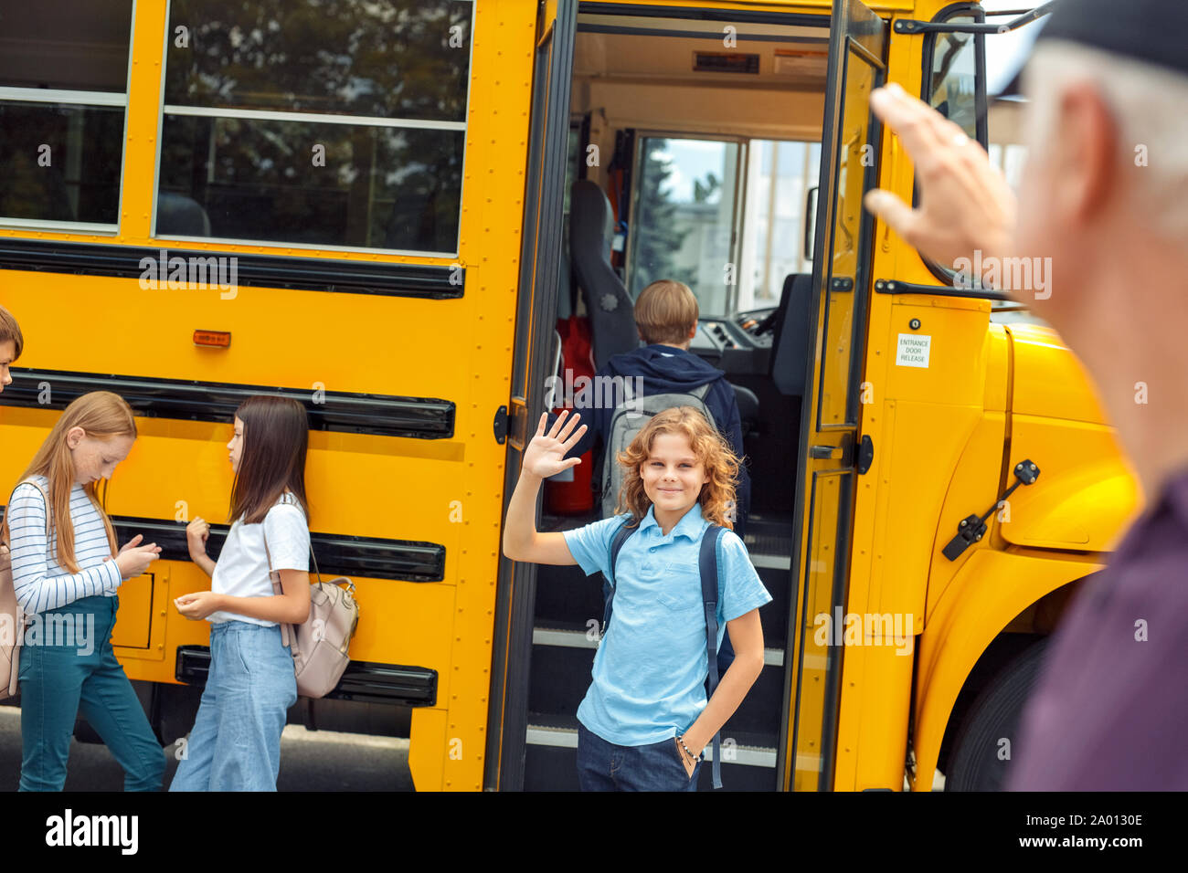 Father waving to son going to school by bus happy Stock Photo - Alamy
