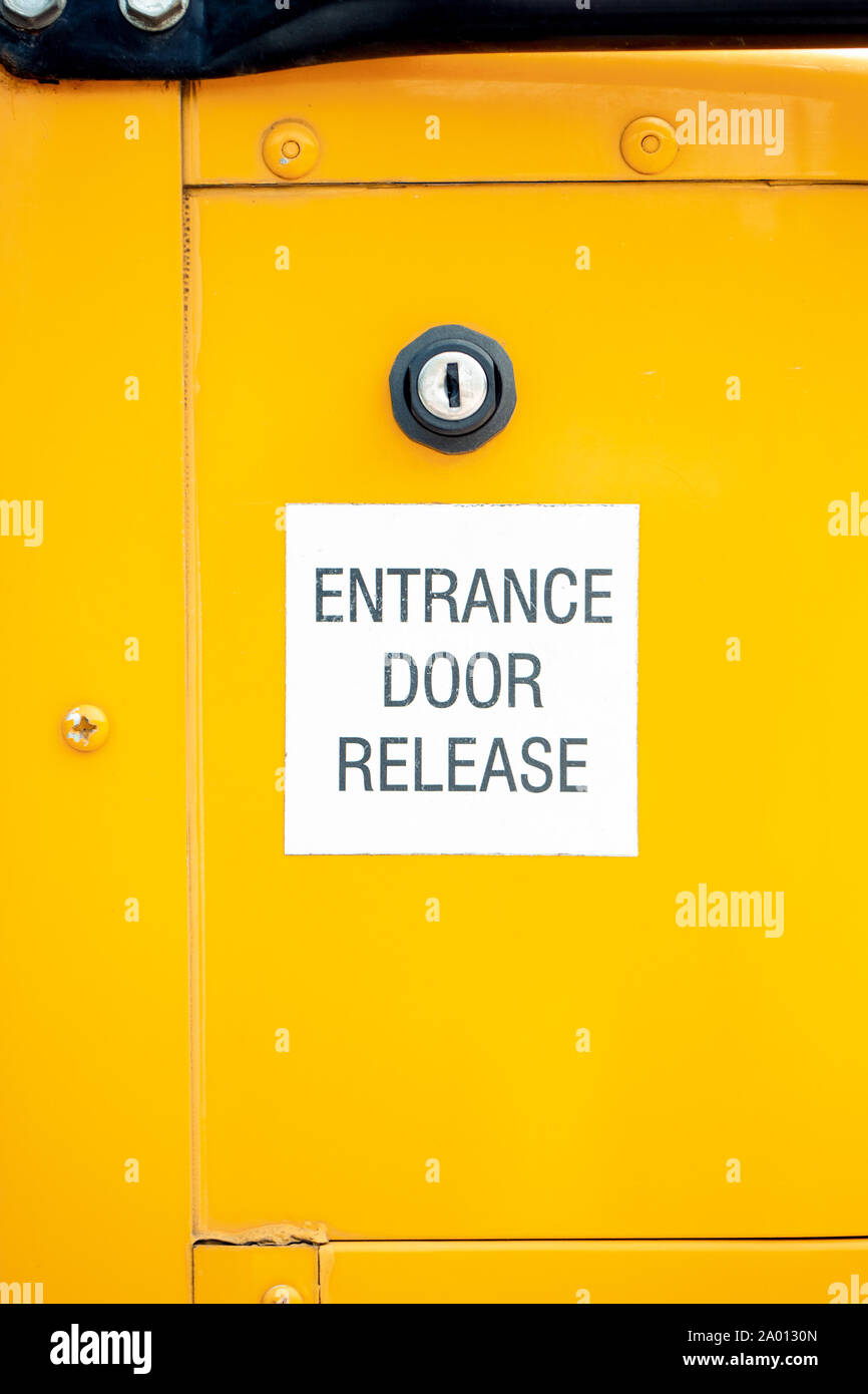 School bus entrance door release sign close-up Stock Photo - Alamy