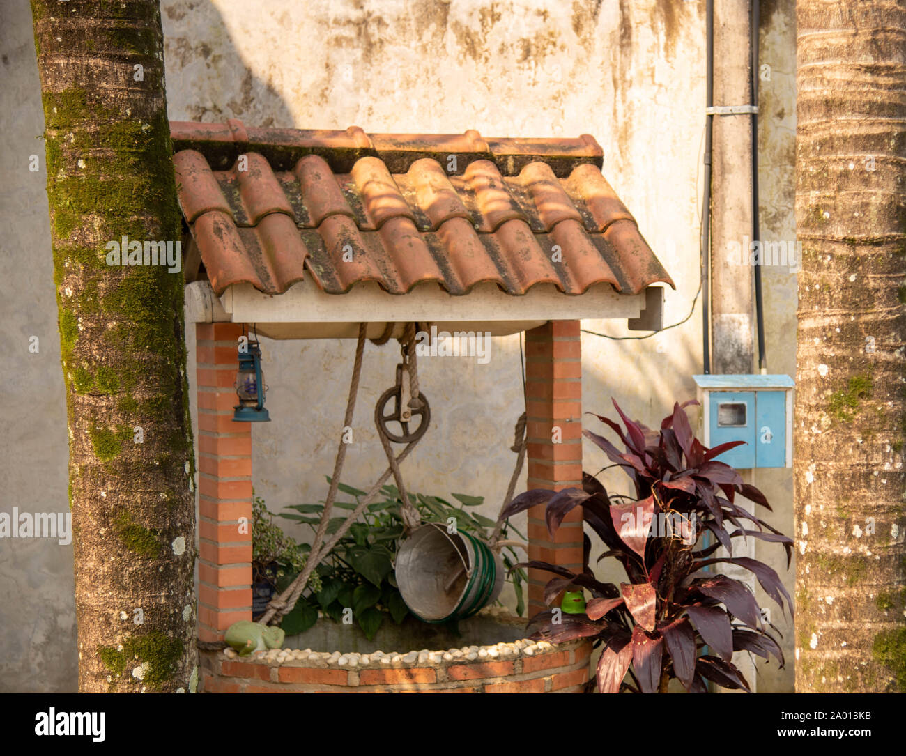 Replica of a fresh water pit, a bucket and other props in the garden of ...