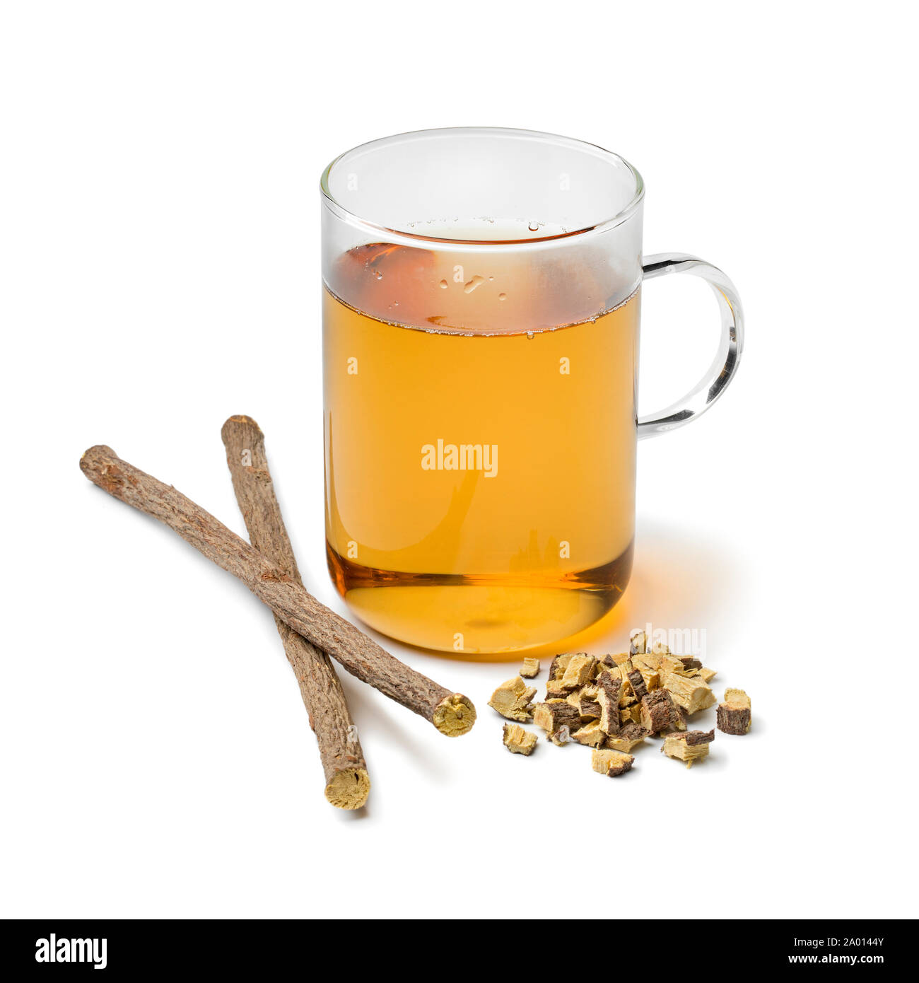 Glass of licorice tea and pieces of roots isolated on white background ...