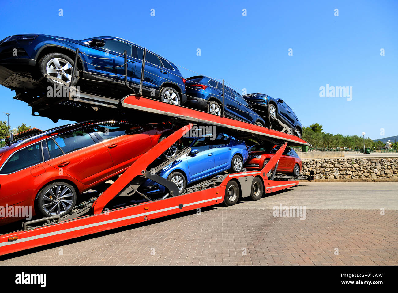 An anuto transporter carries new cars of blue, red colors from the ...