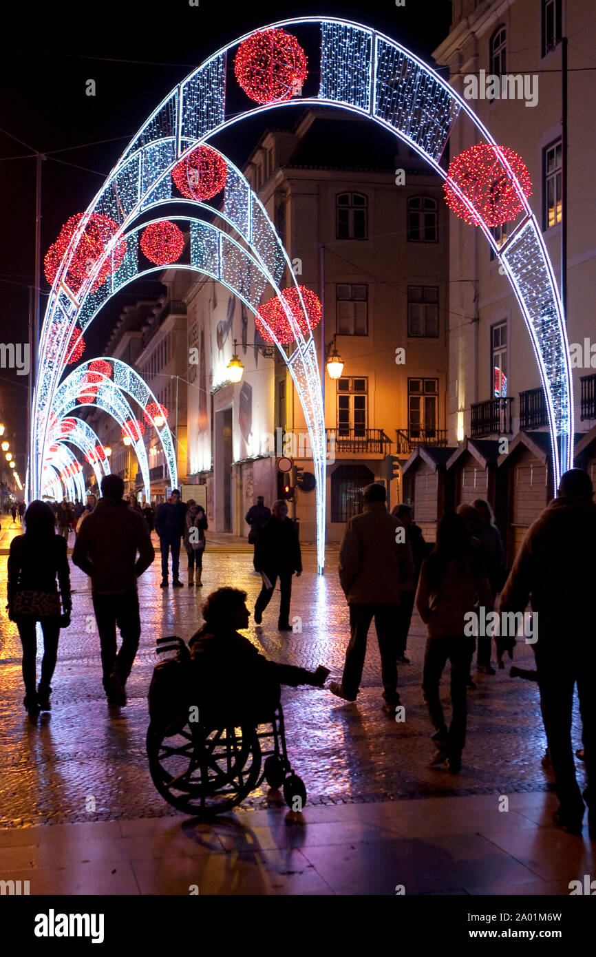 LISBON - Silhouette of a legless beggar in a wheelchair on the Rua ...
