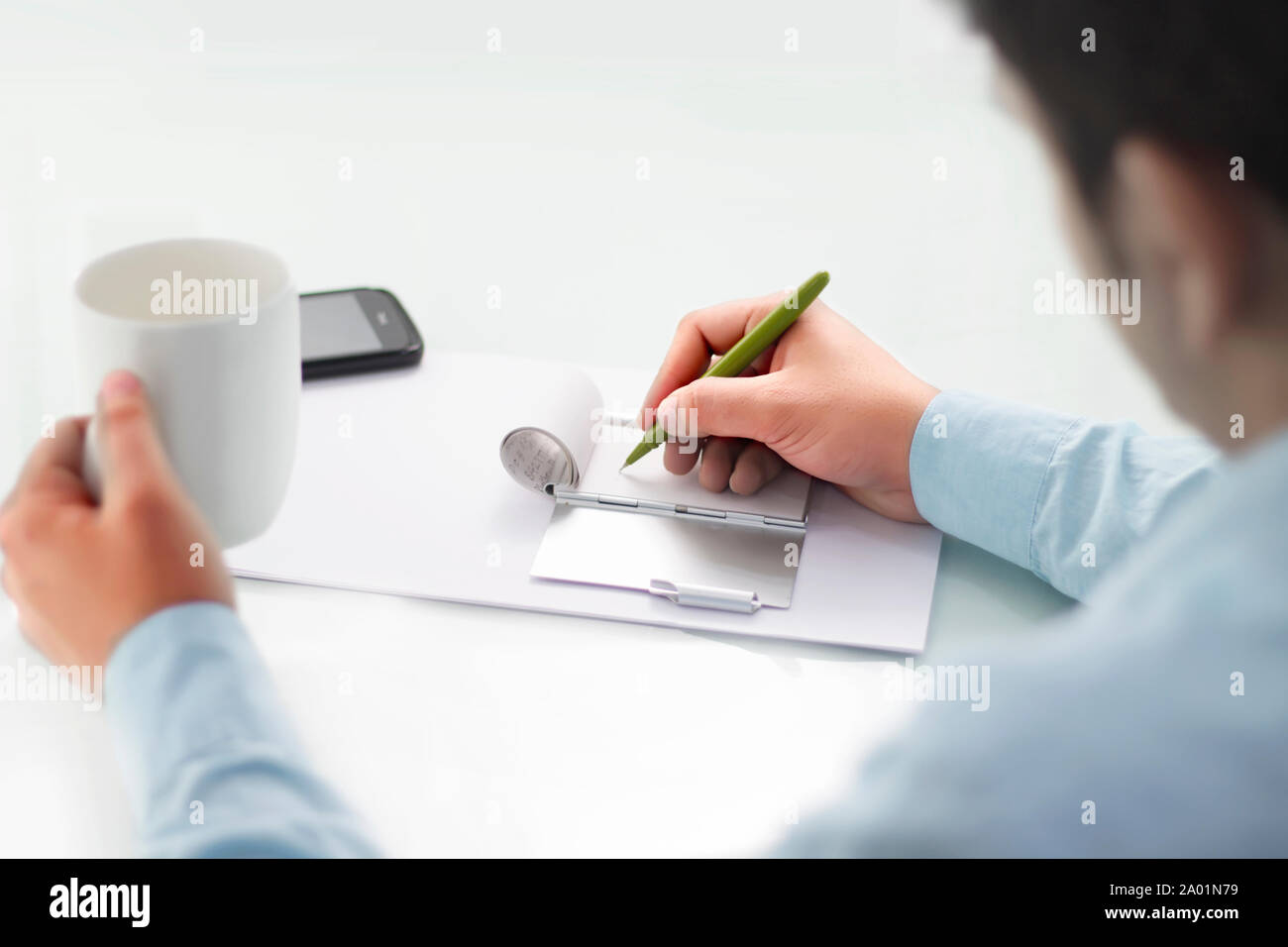 Picture of man working paperwork with a pen. Isolated on a white ...