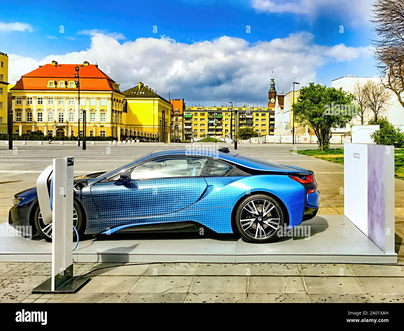 Electric vehicle being plugged in Stock Photo - Alamy