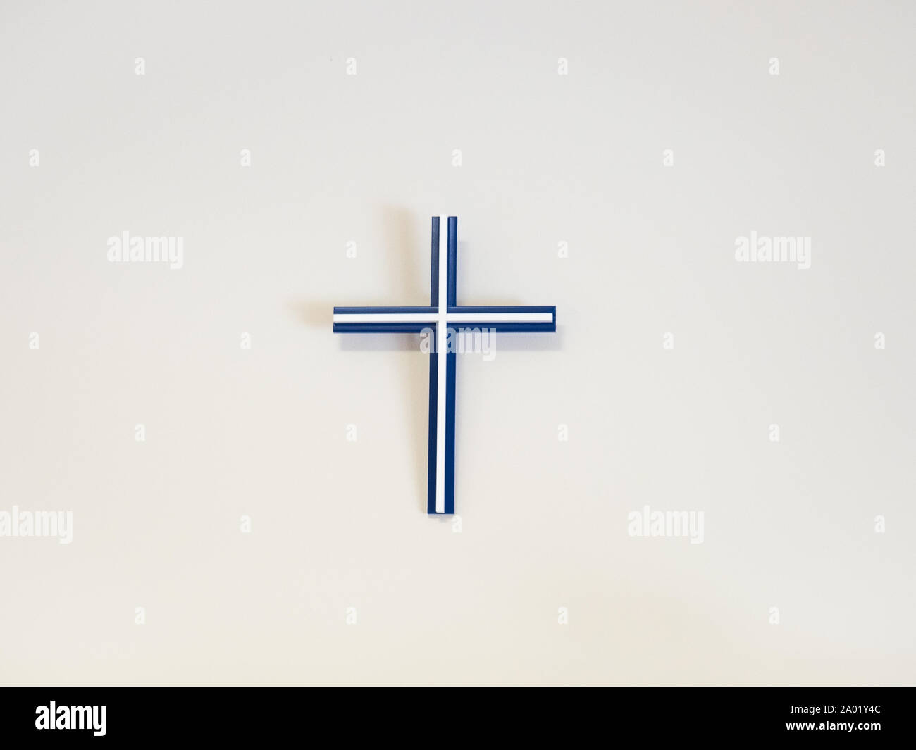 Blue and white catholic cross on a wall Stock Photo - Alamy