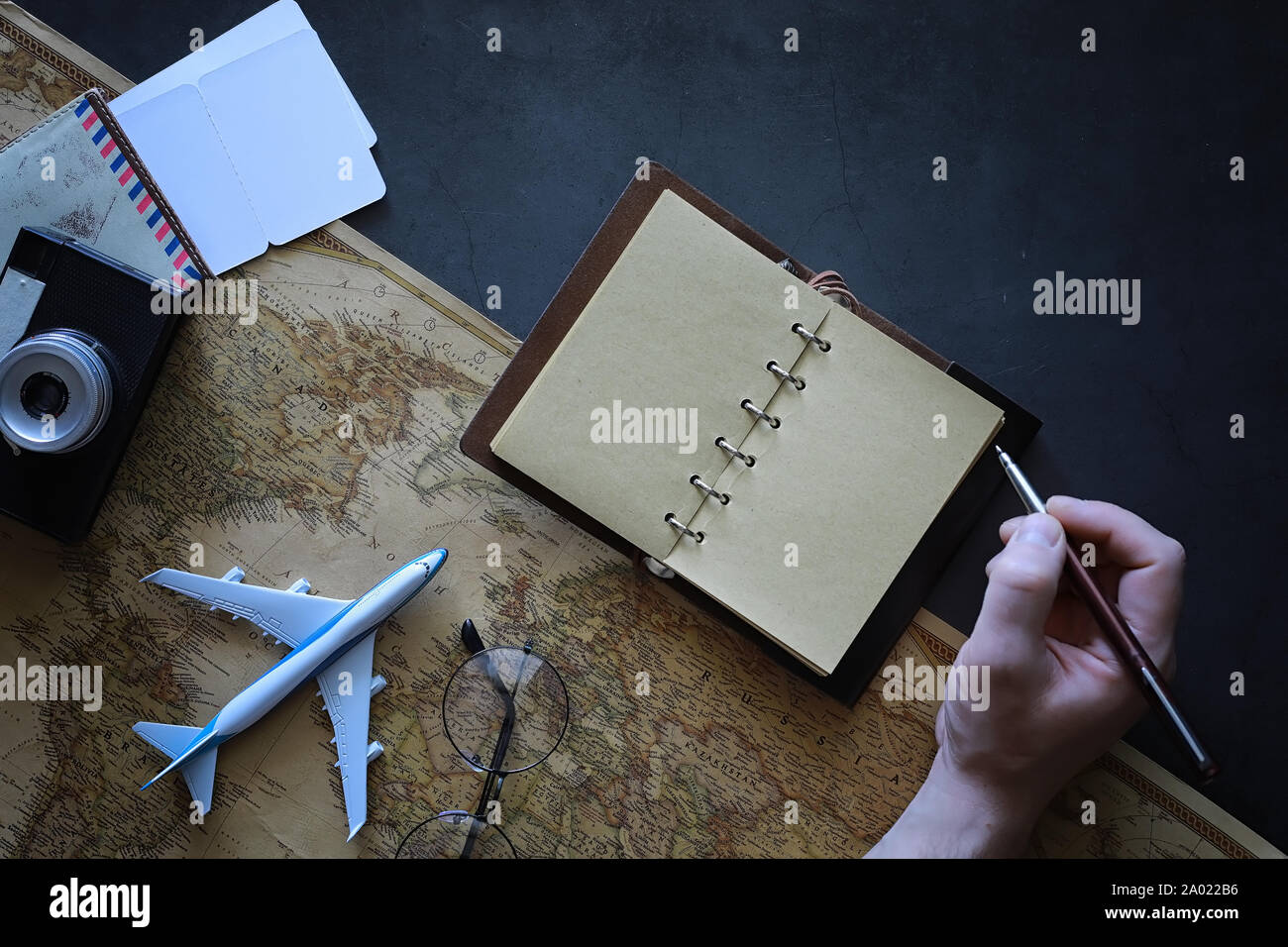 Travel concept. Map on the table andl aircraft Stock Photo - Alamy