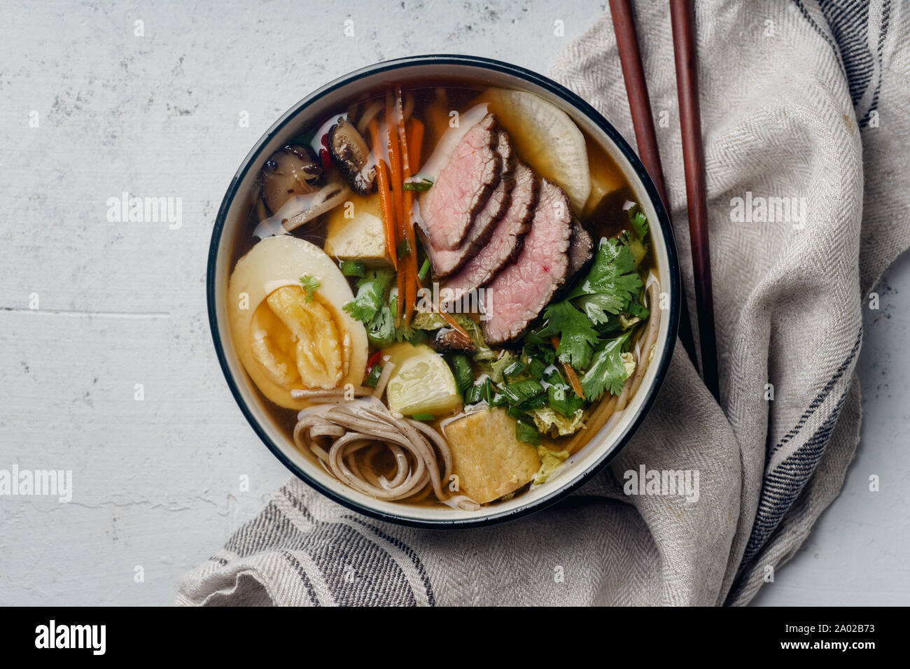 Miso ramen with roasted beef, shiitake mushrooms, fried tofu, leek and ...