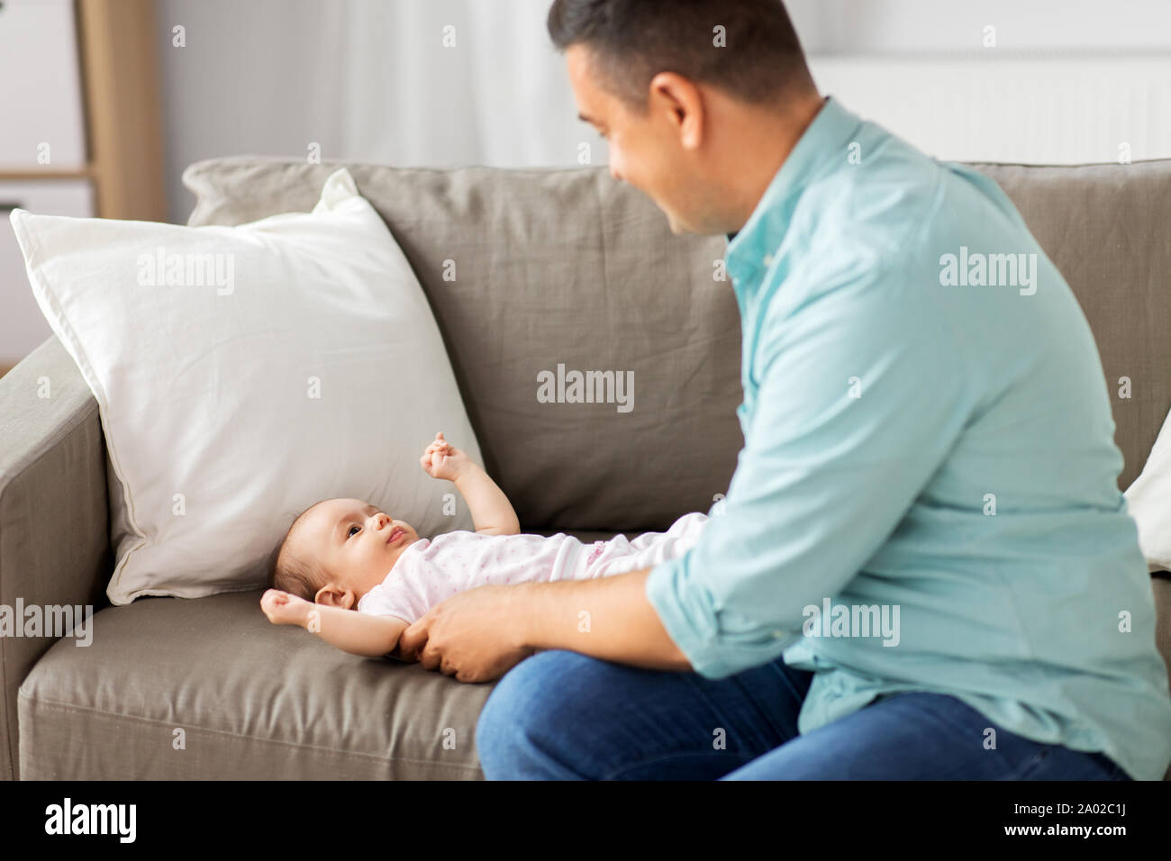 middle aged father playing with baby at home Stock Photo - Alamy