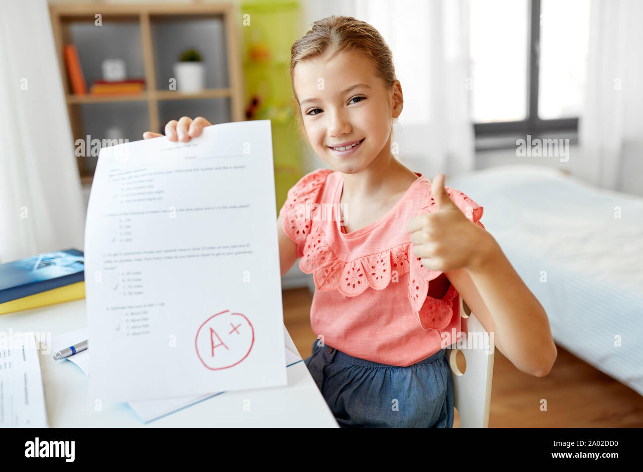 student girl with school test good mark at home Stock Photo - Alamy