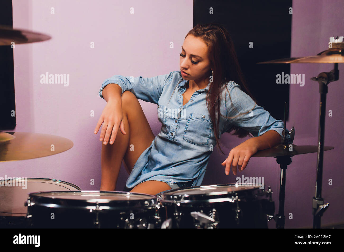 Photograph of a female drummer playing a drum set on stage Stock Photo ...